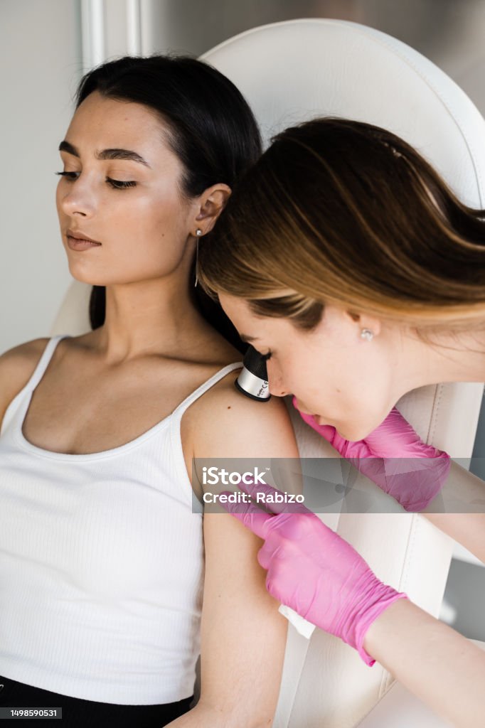 Dermatologist Examines Moles And Birthmarks Of Girl Patient Using