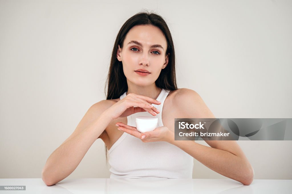 Woman With Healthy Hydrated Skin Holding Jar With Anti Aging Face Cream