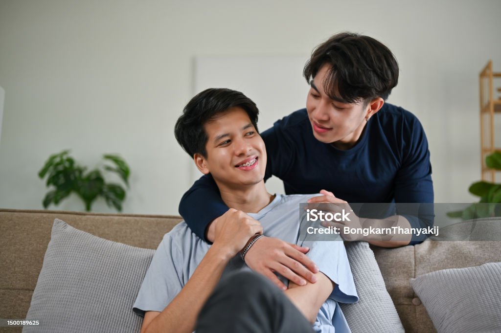 Happy And Carefree Asian Male Gay Couple Hugging Each Other While