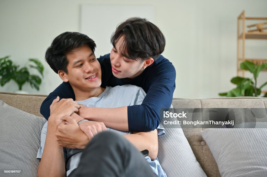 A Happy And Carefree Asian Male Gay Couple Hugging Each Other While