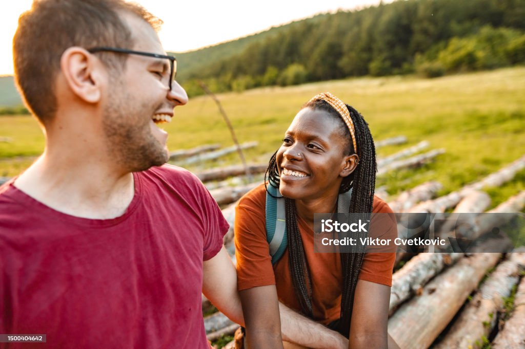 Smiling Multiracial Couple Enjoying Spending Their Day In Nature Stock
