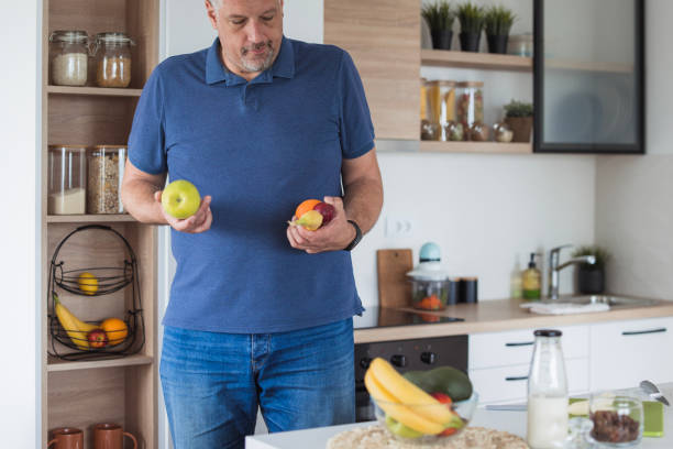 Free Stock Photo of Man Standing Next to Table Filled With Fruit ...