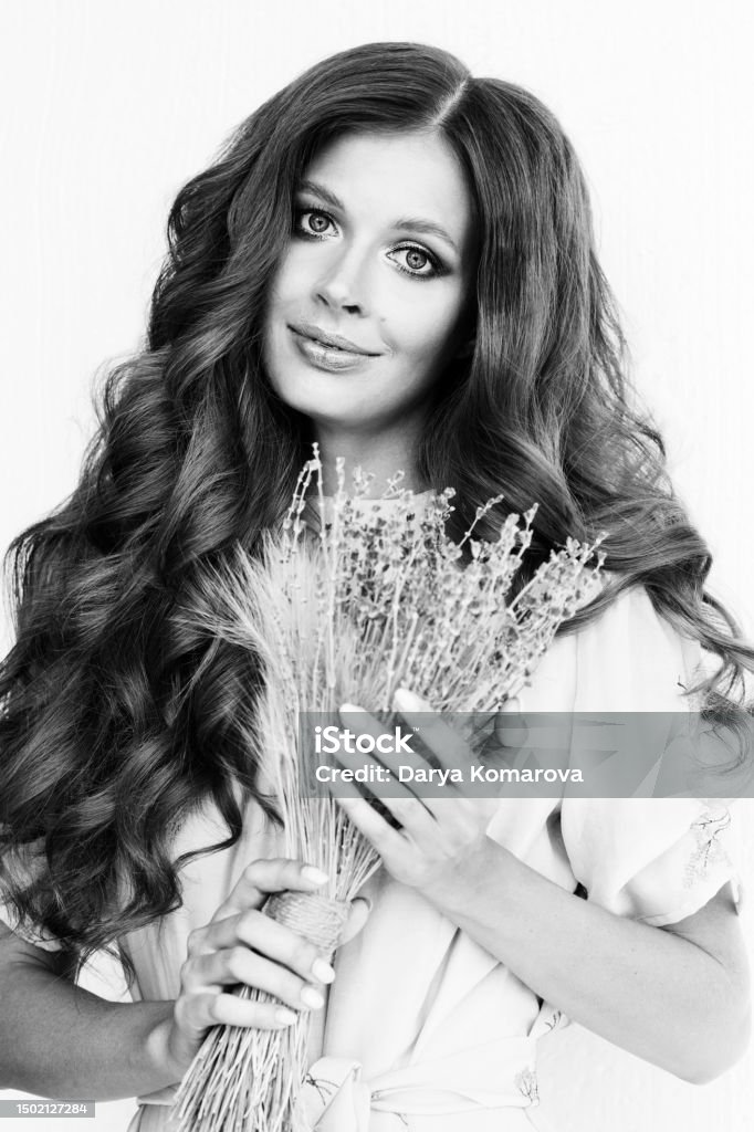 Portrait Of A Beautiful Young Woman With The Wind In Her Long Curly