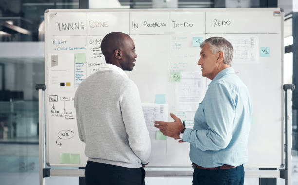Free Stock Photo of Business team discussing at whiteboard in office ...