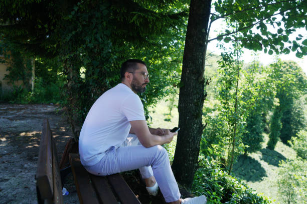 Free Stock Photo of Man Sitting on Bench in Field | Download Free ...