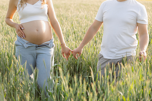 Unrecognizable Married Couple During Their Wifes Pregnancy Enjoys Walk