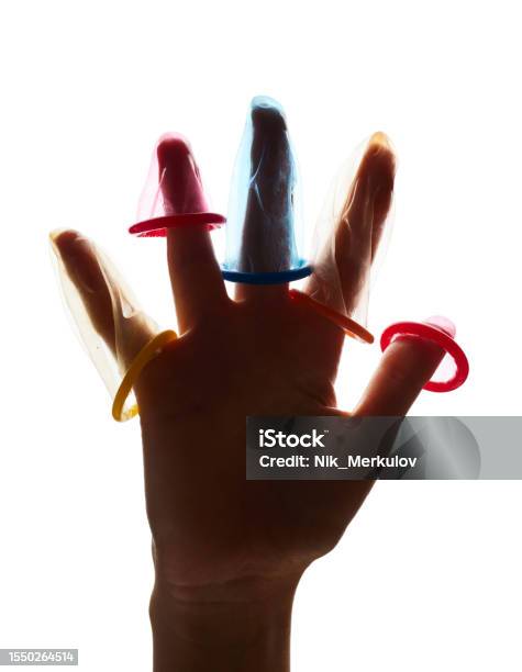 Womans Hand Holding Condoms On Fingers Isolated On White Background