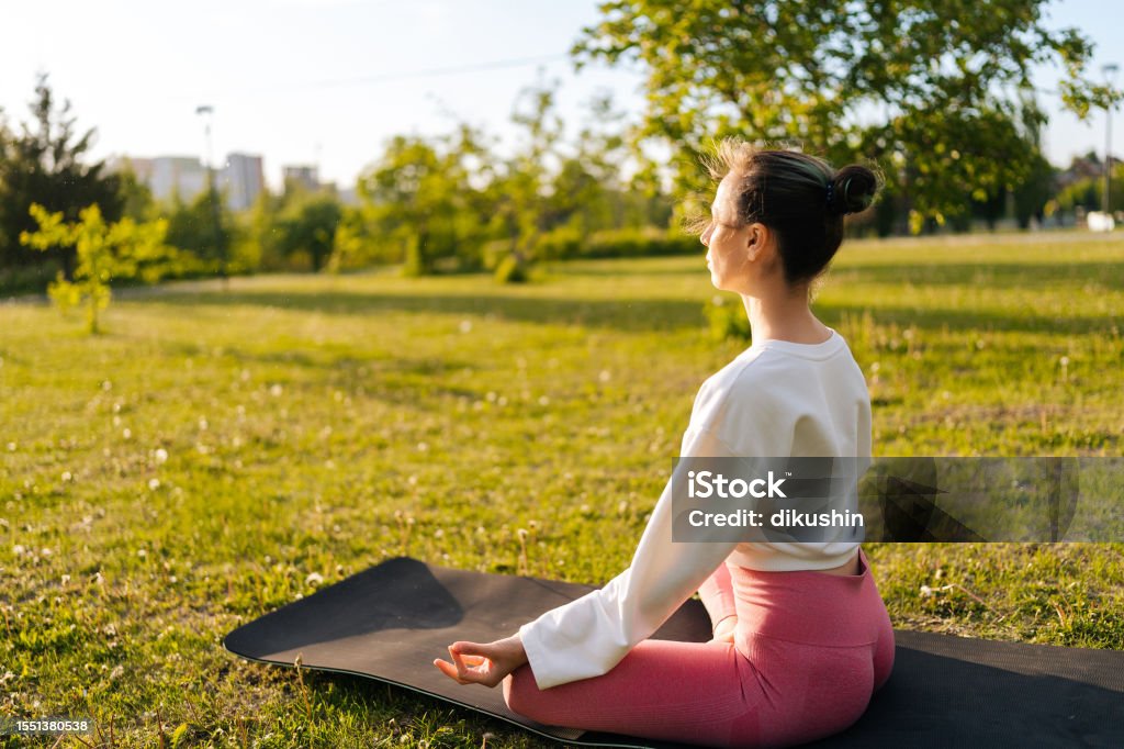 Back Side View Of Unrecognizable Peaceful Yogini Female Wearing White