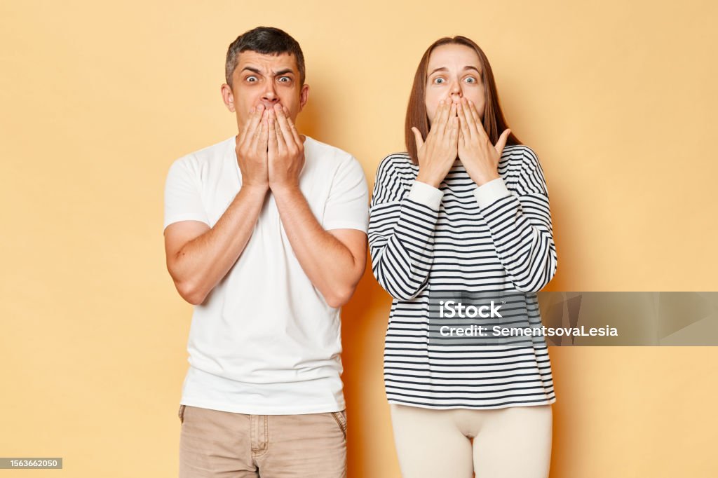 Shocked Astonished Young Couple Wife And Husband Wearing Casual Attires
