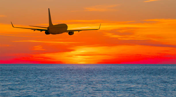 Free Stock Photo of Plane Flying Over Body of Water at Sunset ...