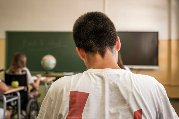 Free Stock Photo of Student in a classroom looking at the back of the ...