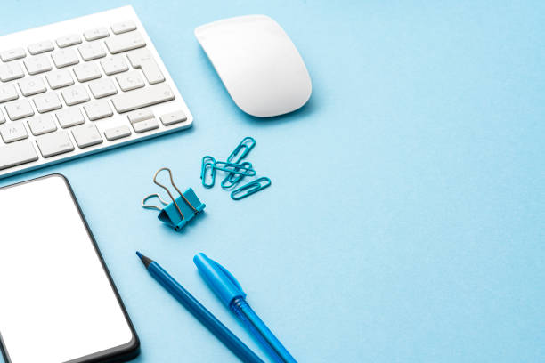 Free Stock Photo of A keyboard and stationery on a blue table ...