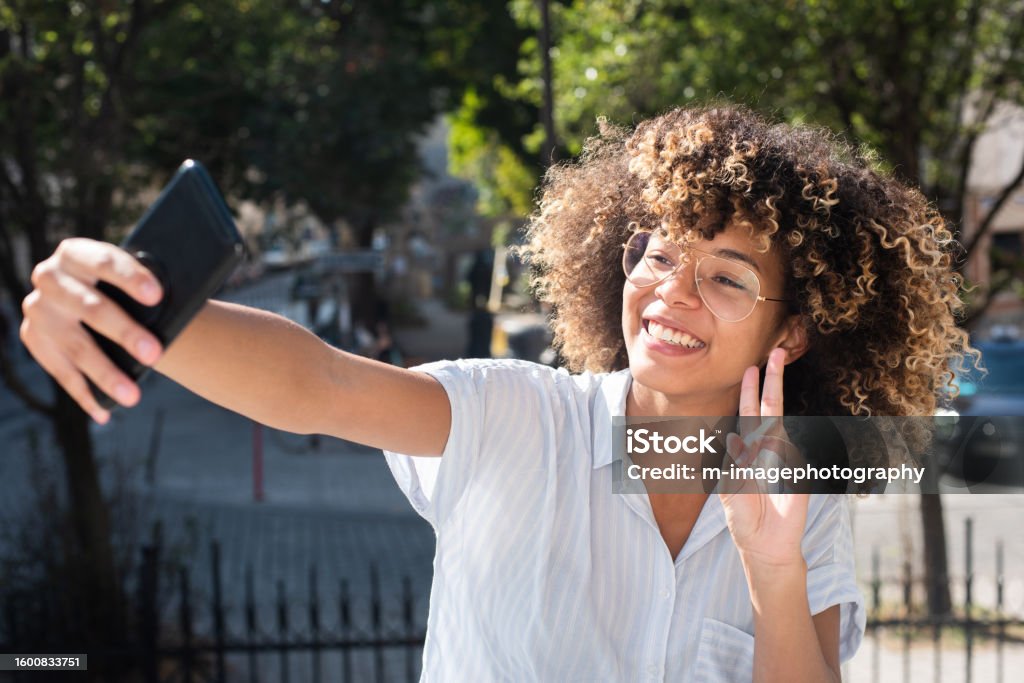 Smiling Young Black Woman Taking Selfie Photo With Mobile Phone Stock