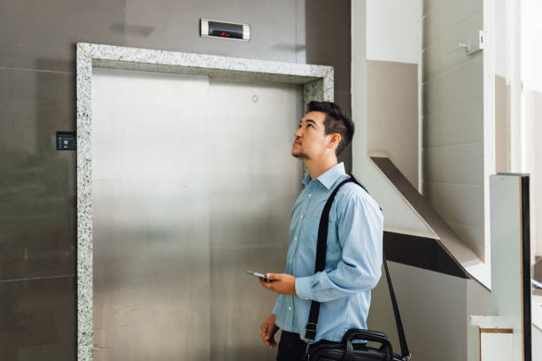 Free Stock Photo of Man waiting for an elevator in a hallway | Download ...