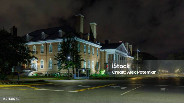 City Hall Building Gable Facade Illuminated By Streetlight At Night