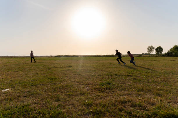 Free Stock Photo of Two children playing football in a misty field at ...