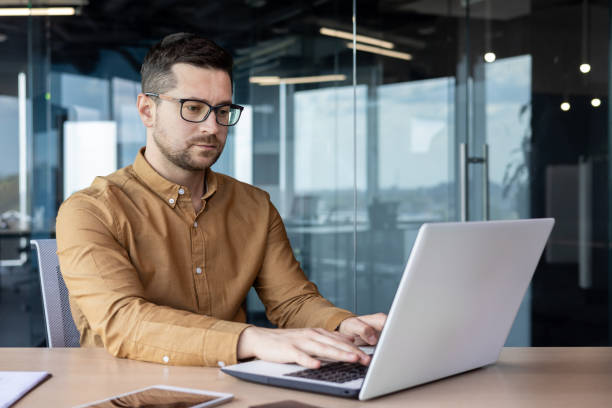 Free picture: Programmer working sitting at a desk with a laptop ...