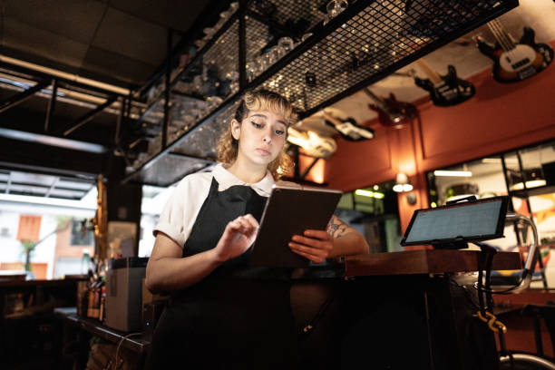 Free Stock Photo of A young woman reading menu at a restaurant table ...
