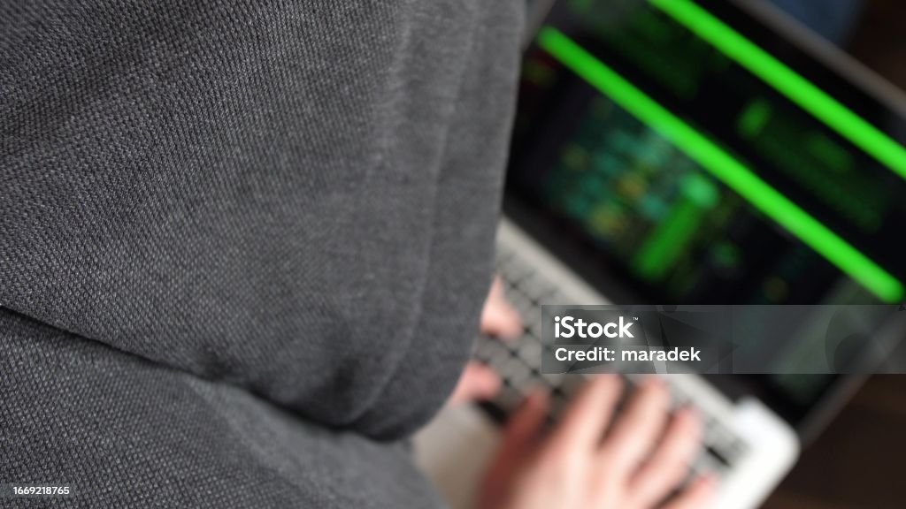 Anonymous Hooded Hacker Programming In Computer Console Breaking
