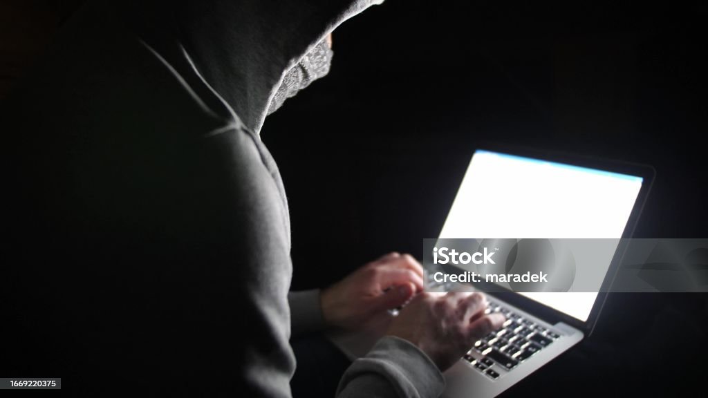 Anonymous Hooded Hacker Programming In Computer Console Breaking