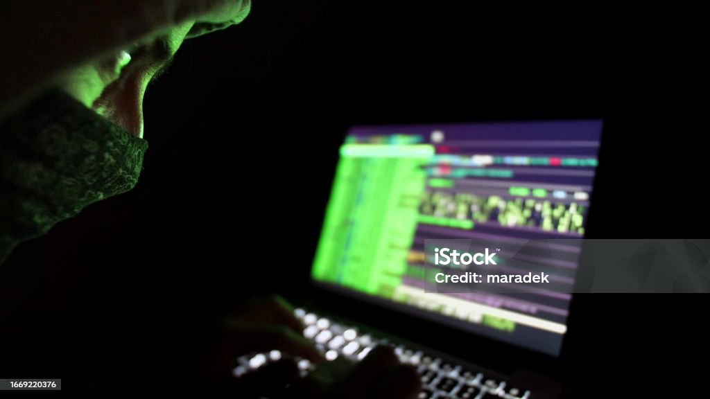 Anonymous Hooded Hacker Programming In Computer Console Breaking