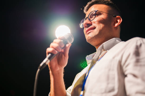 Free Stock Photo of Man Standing on Stage Holding Microphone | Download ...