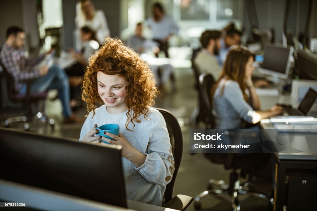 Happy Redhead Programmer Drinking Coffee While Working On Desktop Pc ... Happy Redhead Programmer Drinking Coffee While Working On Desktop Pc ...