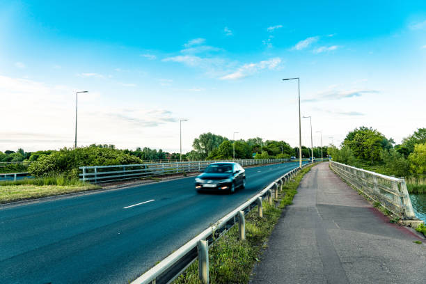 Free Stock Photo of Car Driving on Road With Bridge in Background ...