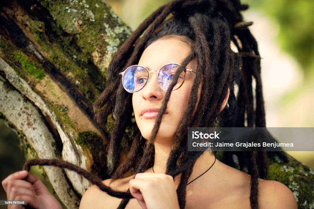 Portrait Of Beautiful Young Woman With Glasses And Style And Dreadlocks