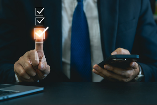 Businessman Using Finger To Tick Correct Sign Mark In Virtual Checkbox Screen For Quality