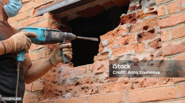 A Builder Destroys A Brick Wall With A Hammer To Make A Window Stock ... A Builder Destroys A Brick Wall With A Hammer To Make A Window Stock ...
