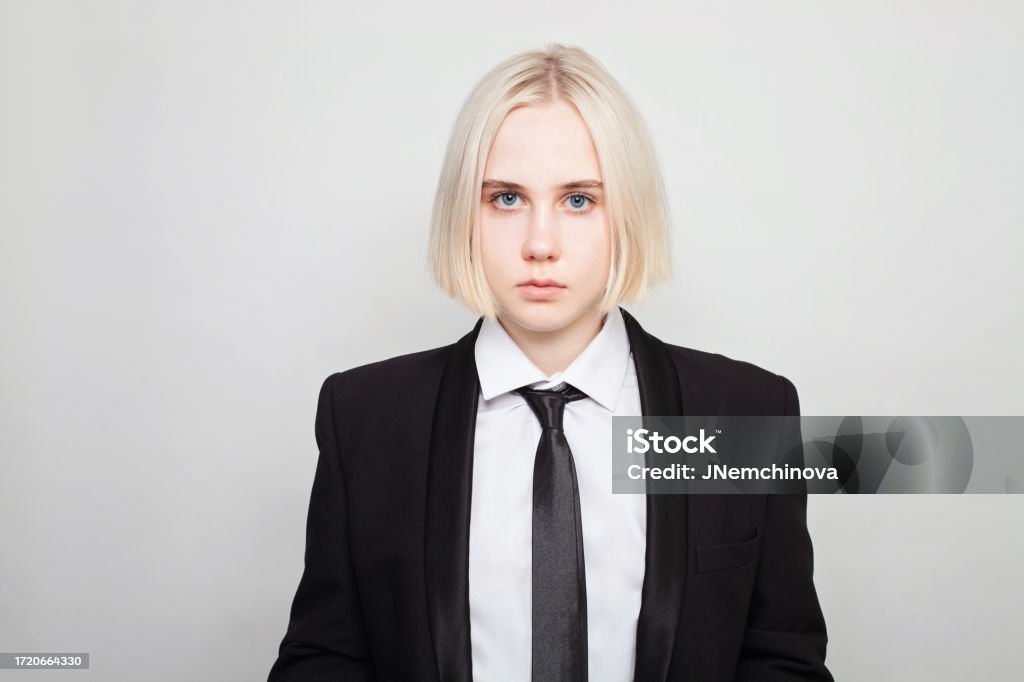Stylish Young Adult Woman Wearing Suit And Tie For Prom Party On White