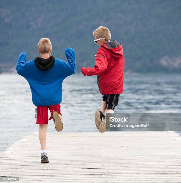 Two Happy Boys Running And Jumping On A Dock Stock Photo - Download ... Two Happy Boys Running And Jumping On A Dock Stock Photo - Download ...