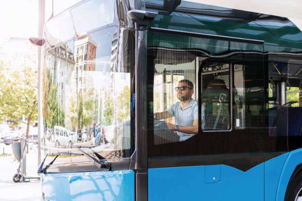 Free Stock Photo of Man Driving Bus Down City Street | Download Free ...