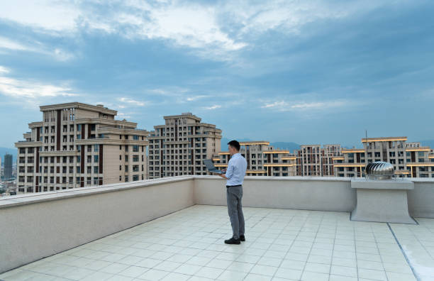 Free Stock Photo of Man Standing on Top of Building Next to Tall ...