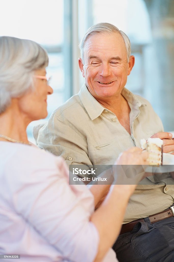 A Senior Woman Giving A Slice Of Cake To Her Happy Husband Stock Photo ... A Senior Woman Giving A Slice Of Cake To Her Happy Husband Stock Photo ...