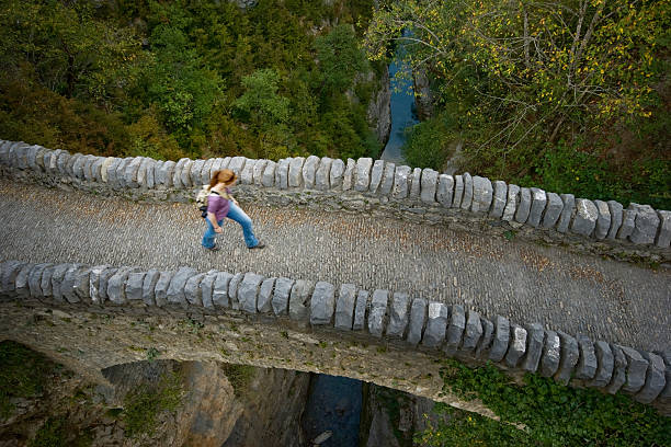 Free Stock Photo of Woman Sitting on Rock Near Bridge | Download Free ...