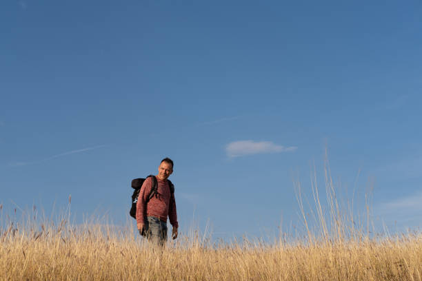 Free Stock Photo of Man Walking Through a Field of Tall Grass ...