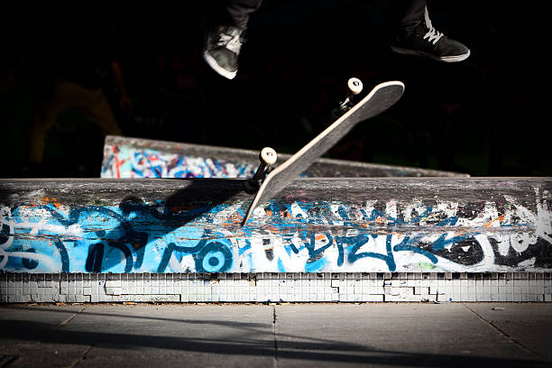 Free Stock Photo of Skateboarder performing trick on graffiti ledge ...