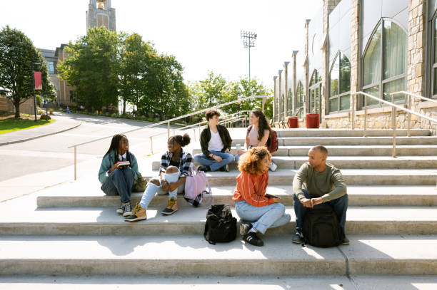 Free Stock Photo of Group of People Sitting on the Steps of a Building ...