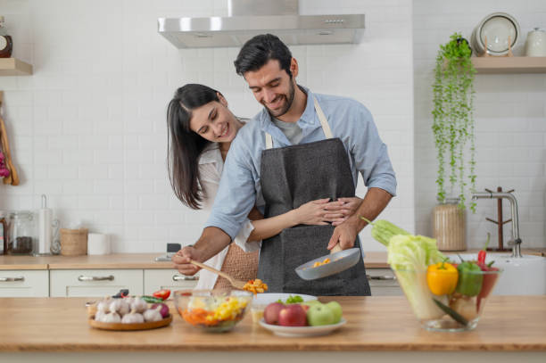 Free Stock Photo of Two young men cooking together in a modern kitchen ...