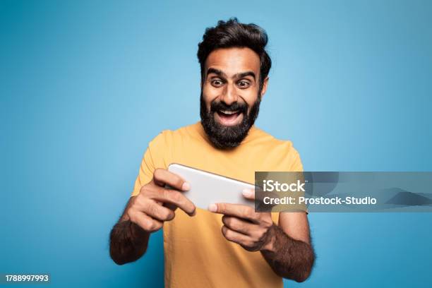 Gadget Addiction Concept Happy Middle Aged Indian Man Playing Mobile Games On Cellphone Isolated 2100