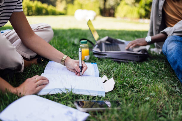 Free Stock Photo of Person Sitting in Grass Writing on a Notebook ...