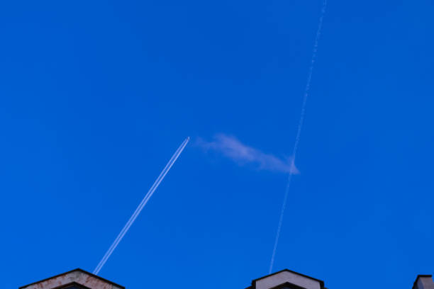 Free Stock Photo of A tall building with a jet trail in the sky ...
