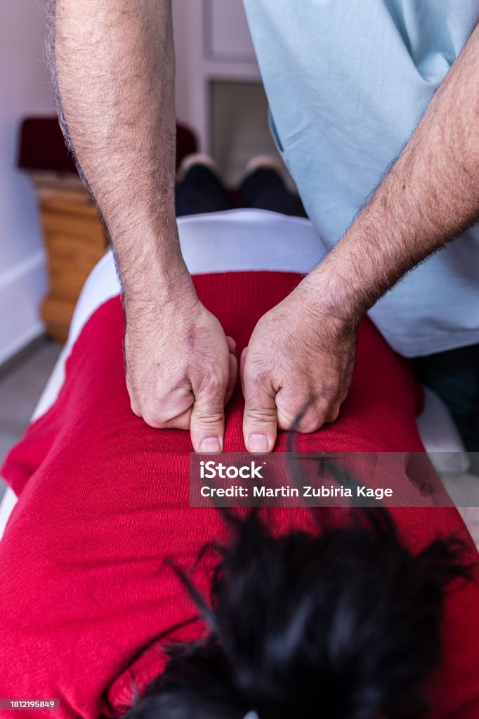 Focused Vertical Photo Of A Mans Hands Massaging His Patients Back