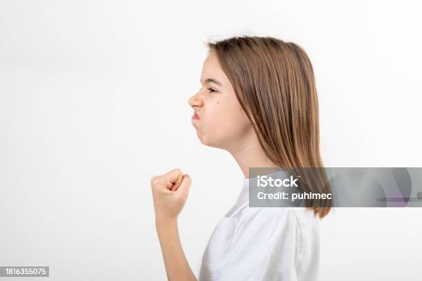 Teenager Girl Shows Fist On White Background Isolated Side View Stock