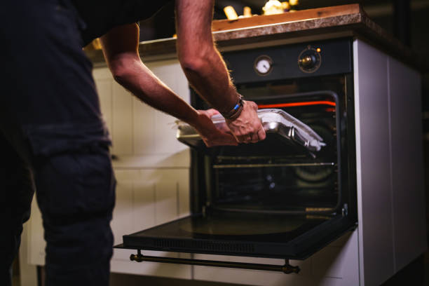 Free Stock Photo of Man Putting Something in the Oven | Download Free ...