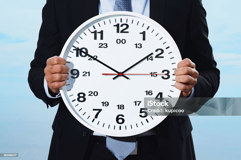 Mid Section Of A Punctual Business Man Holding Clock Stock Photo ... Mid Section Of A Punctual Business Man Holding Clock Stock Photo ...