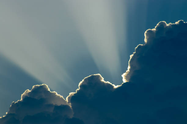 Free picture: Sun shining through dark blue clouds in the sky