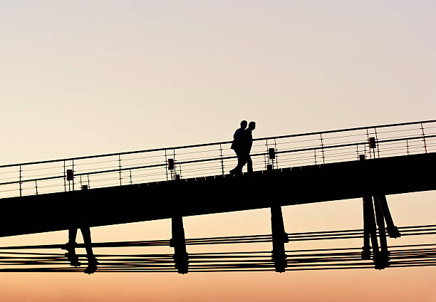 Free Stock Photo of Man Walking Across Bridge With City Background ...